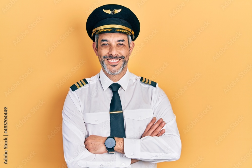 Handsome middle age man with grey hair wearing airplane pilot uniform ...