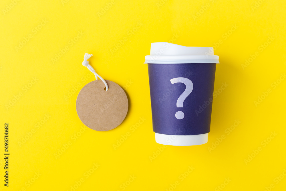 Blue paper coffee cup mockup with question mark and tag label on yellow ...