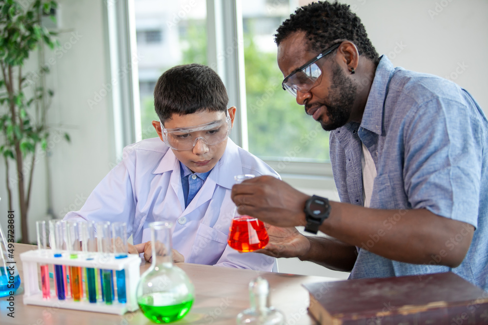 Students mixes chemicals in beakers. enthusiastic teacher explains ...