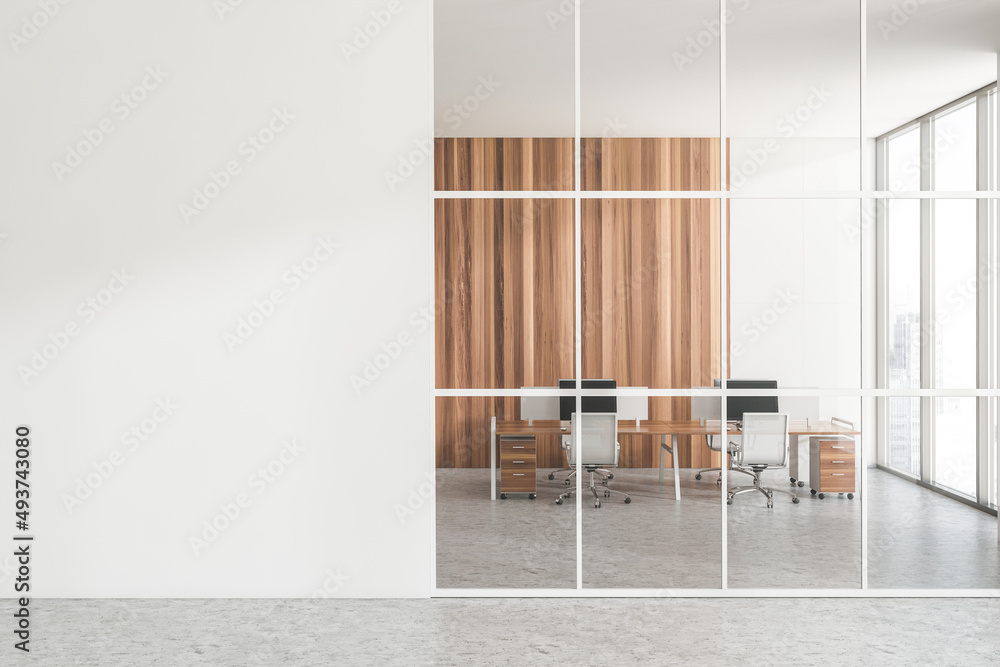 Light coworking interior with computers behind glass doors, window and ...