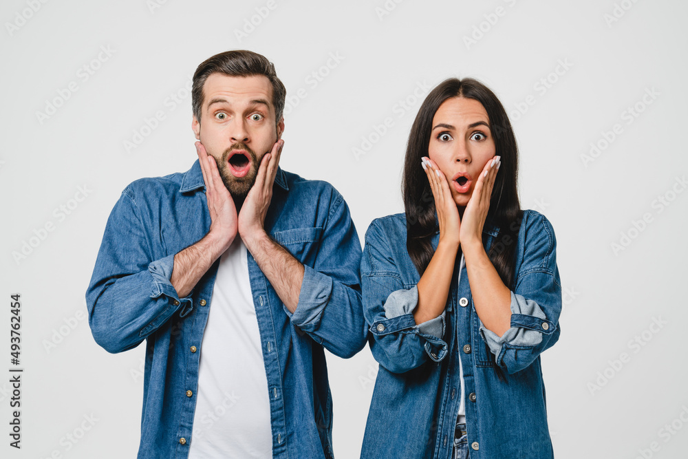 Shocked surprised amazed caucasian young couple spouses husband and ...
