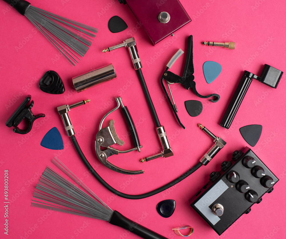 Music equipment on a hot pink background. Guitar accessories. Stock ...