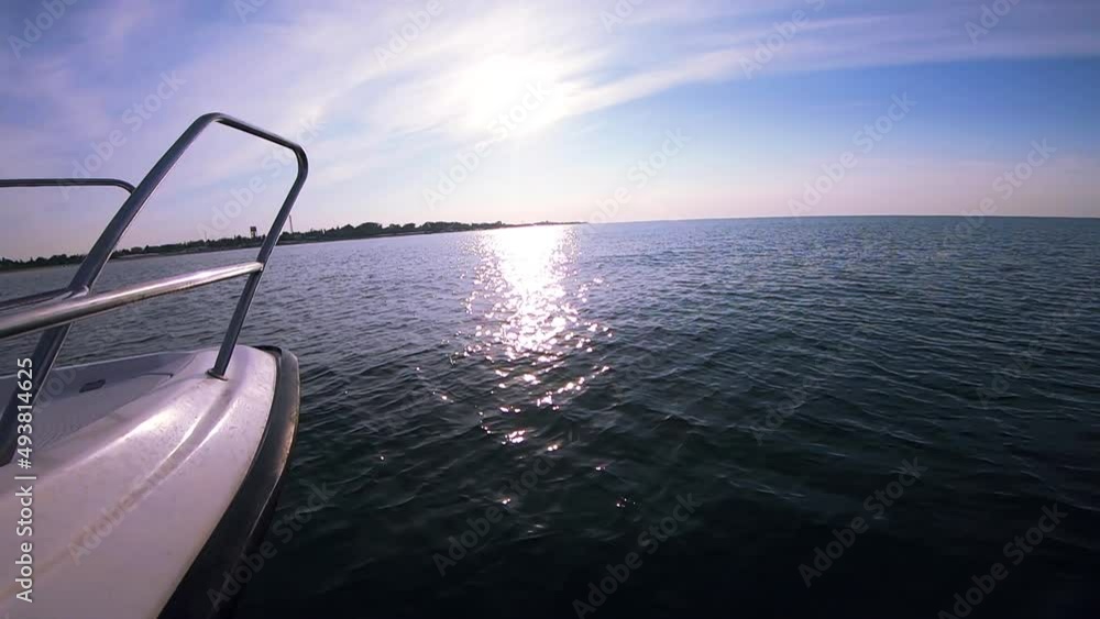 Seascape, view of sea waves with sun reflection from prow of motorboat ...