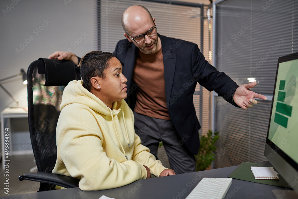 Side view portrait of mature business manager instructing female ...