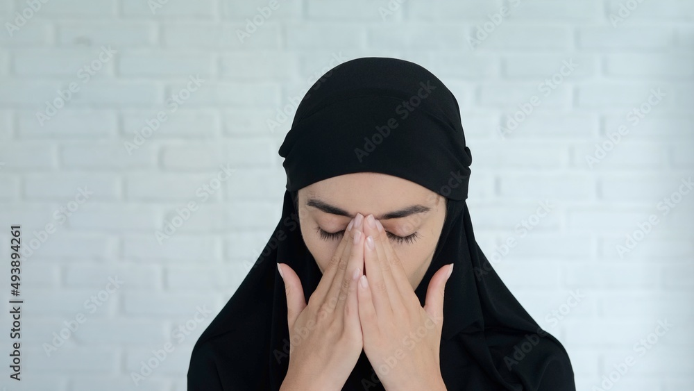 Crying Muslim woman in a black hijab violence and restriction of ...