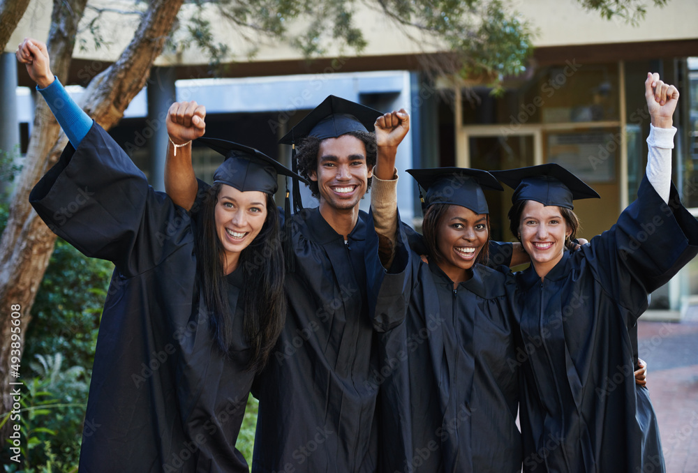 Nothing can stop us now. A group of smiling college graduates ...