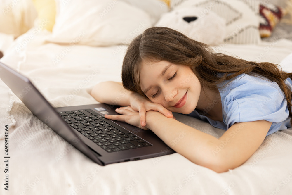 cute teen girl sleeping on laptop Stock Photo | Adobe Stock