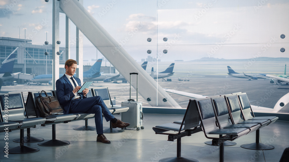 Airport Terminal Flight Wait: Smiling Businessman Uses Digital Tablet ...
