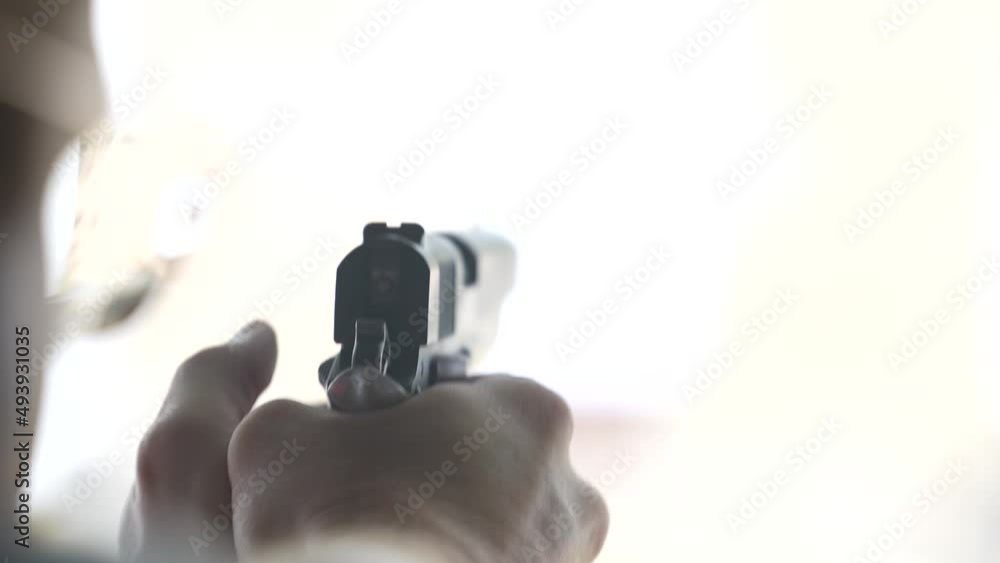 A man shoots with a pistol at targets at a shooting range, close-up ...