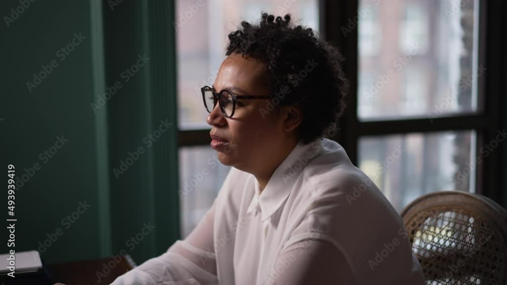 4k Portrait of young businesswoman talking and sitting at table in ...