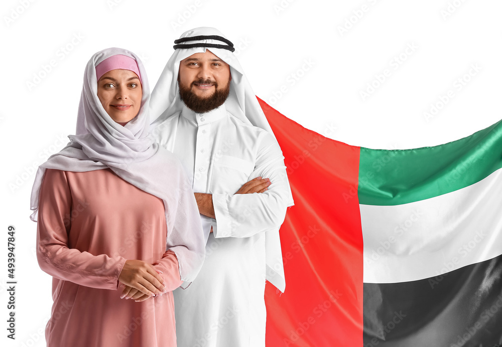 Couple in traditional clothes and with the national flag of UAE on ...