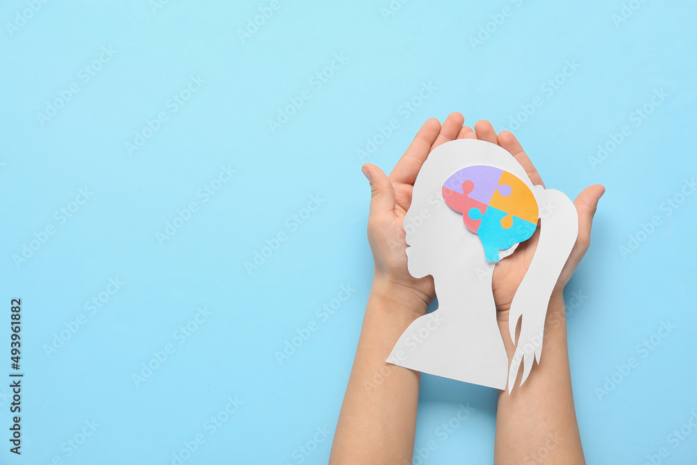 Child with paper female head on blue background. Concept of autistic ...