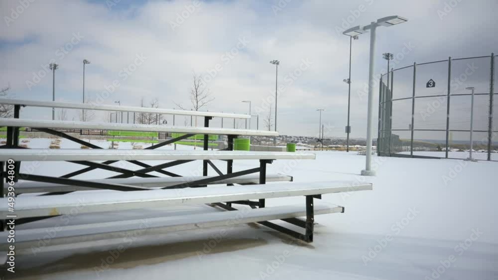 Bleachers at baseball and softball fields covered in fresh snow during ...