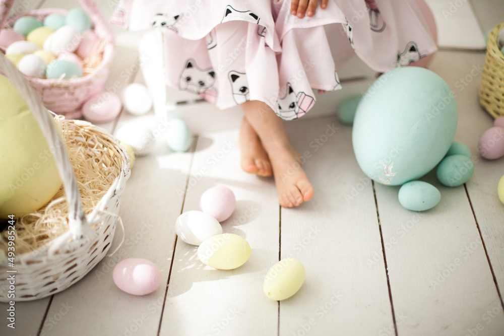 little girl in easter decoration with easter eggs and easter bunnies ...