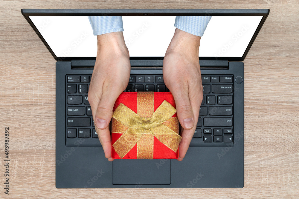 Hands with a gift come out from a screen of computer Stock Photo ...