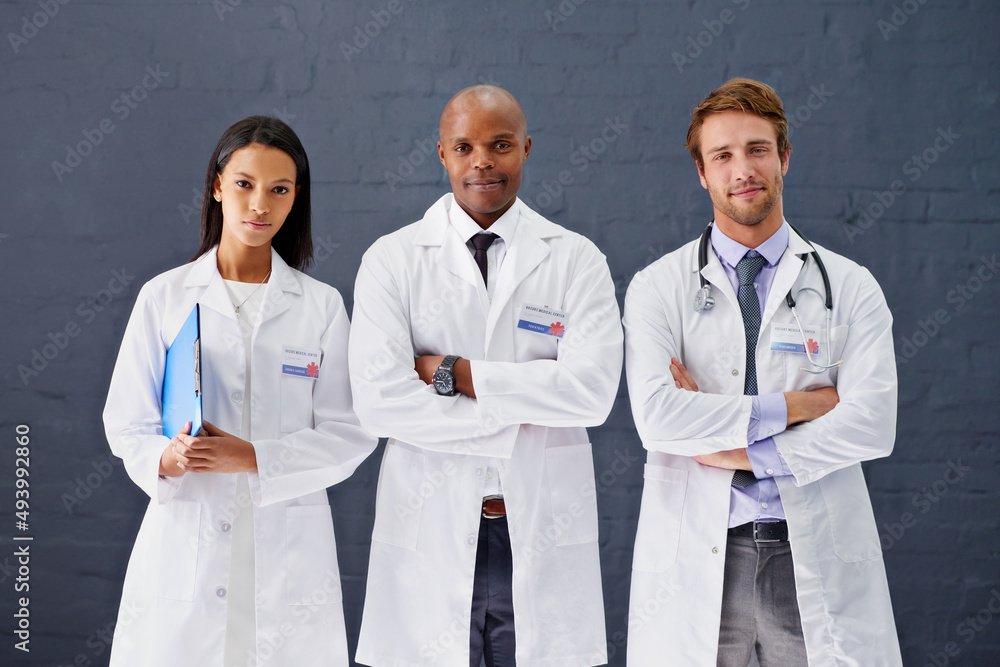 No doctor can do it on their own. Portrait of three doctors standing ...