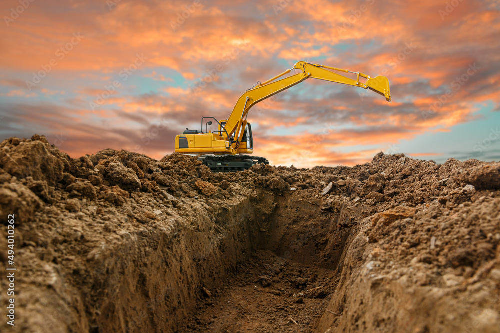 Excavators silhouette are digging soil with bucket lift up in the ...
