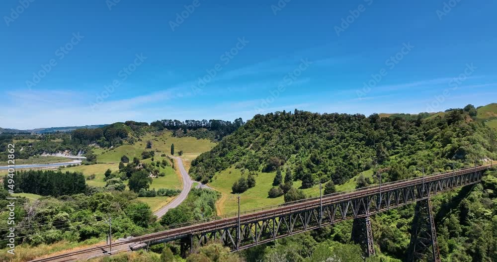 Flying over Mangaweka rail bridge towards highway lush fields - New ...