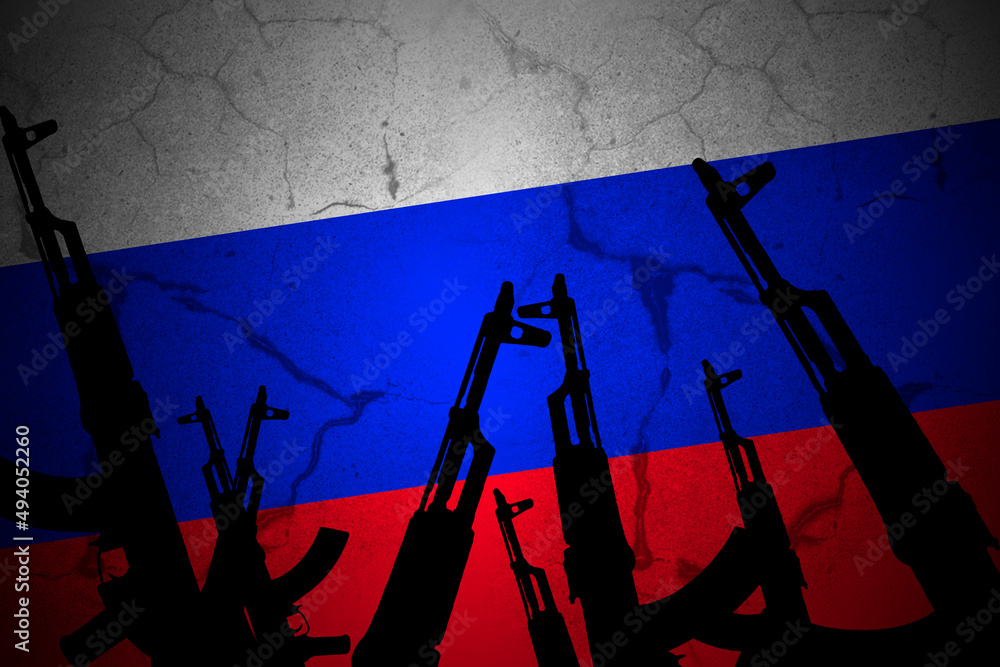 Assault rifles against the background of flags. Russian-Ukrainian ...