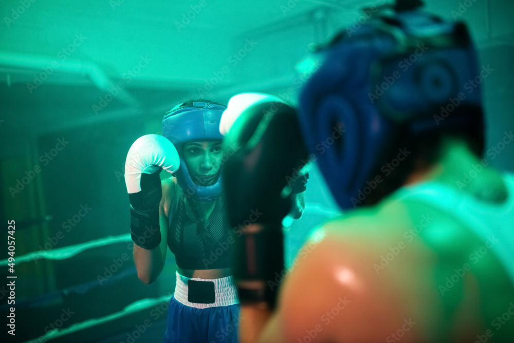 Close-up of boxing girls on ring. Two young girls in helmets and gloves ...