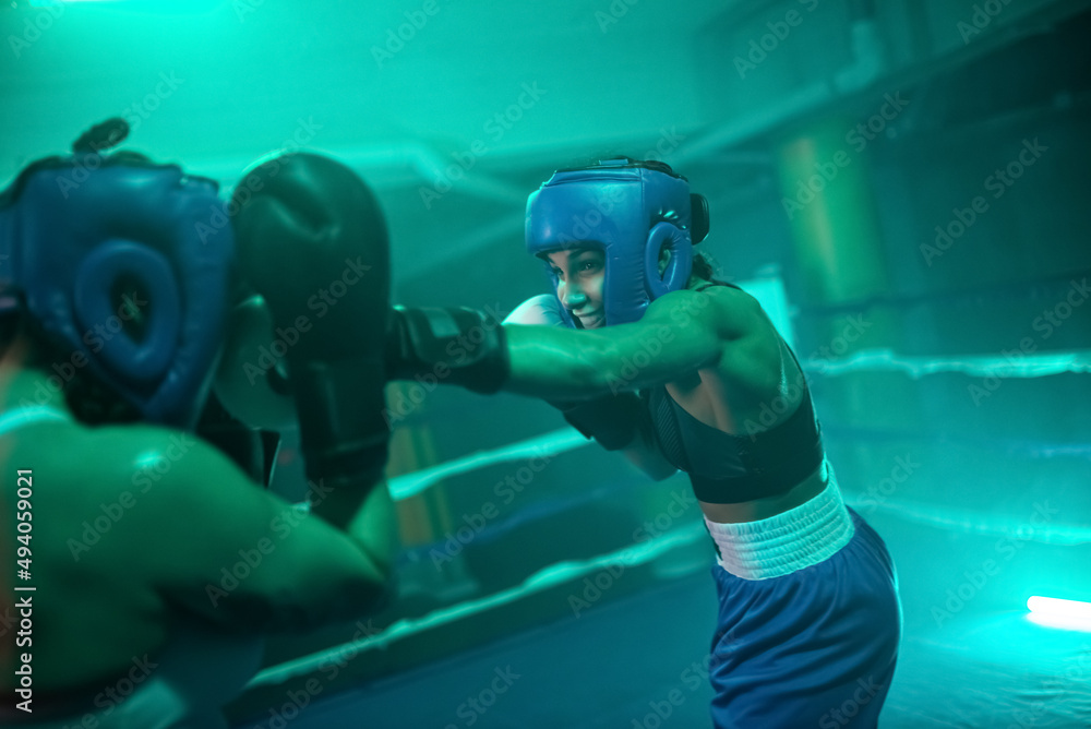 Happy boxer girls enjoying sparring together on ring. Two strong girls ...