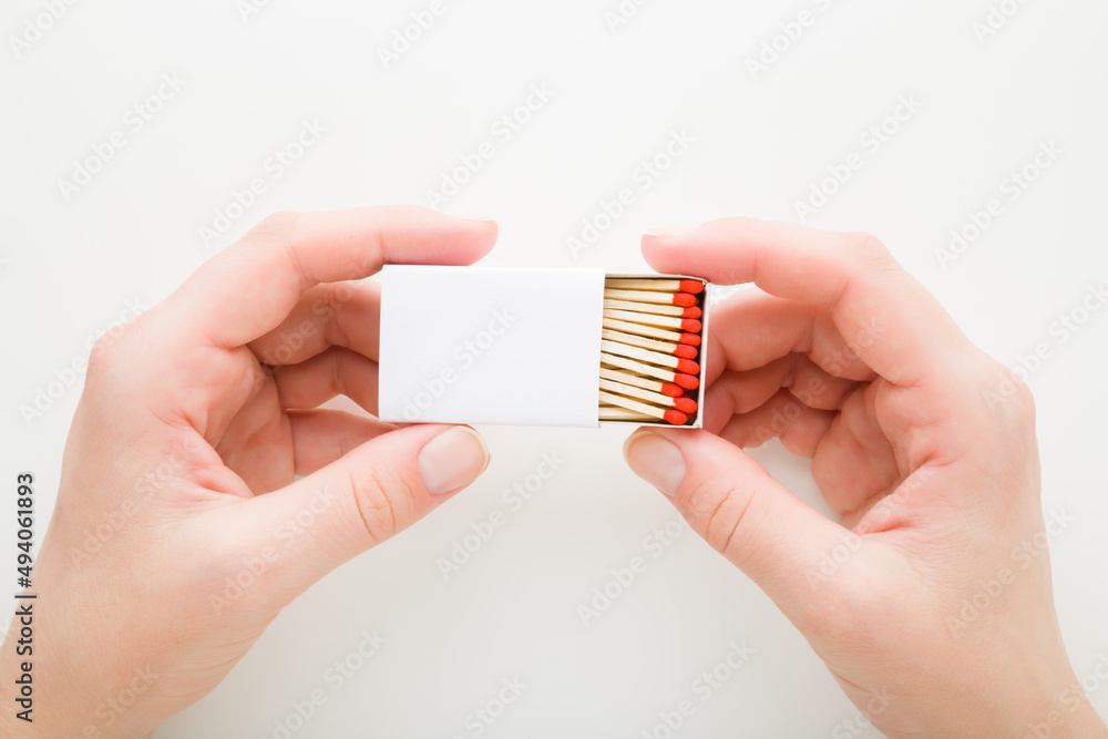 Young adult woman hand holding and showing opened box of match sticks ...