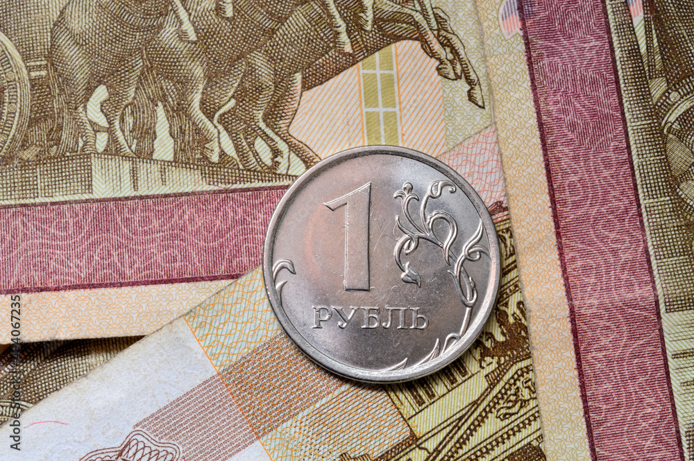 Russian coin with a face value of 1 ruble lies on a banknote ...
