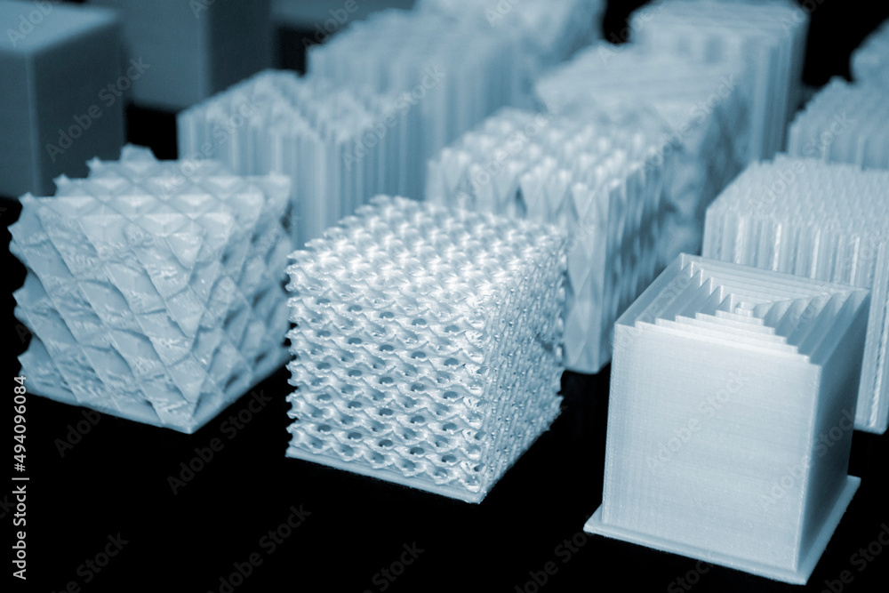 Objects printed on 3d printer made of white plastic close-up. Models ...