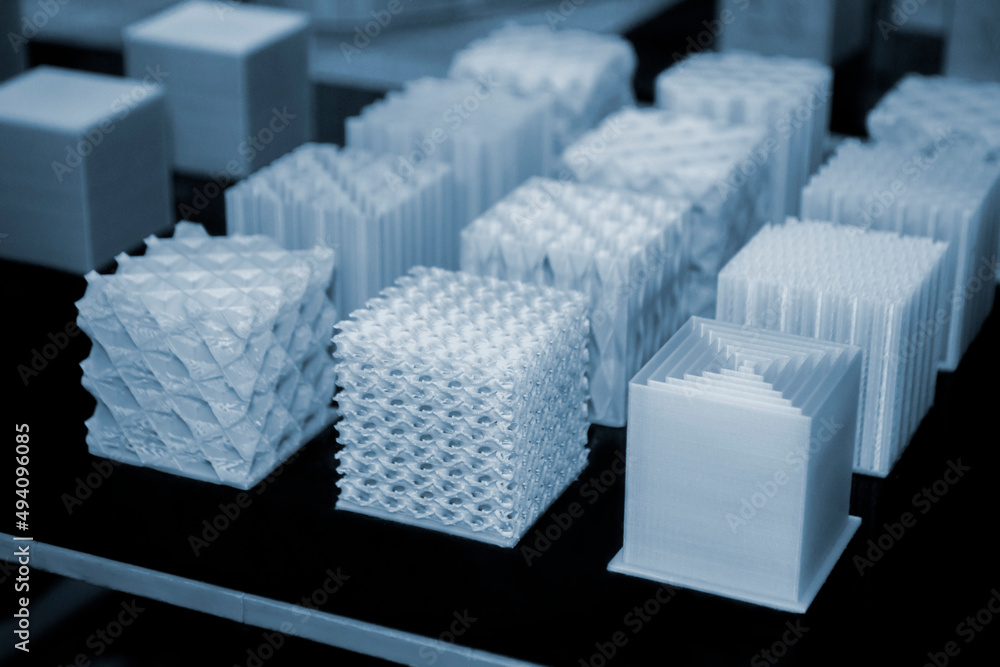 Objects printed on 3d printer made of white plastic close-up. Models ...