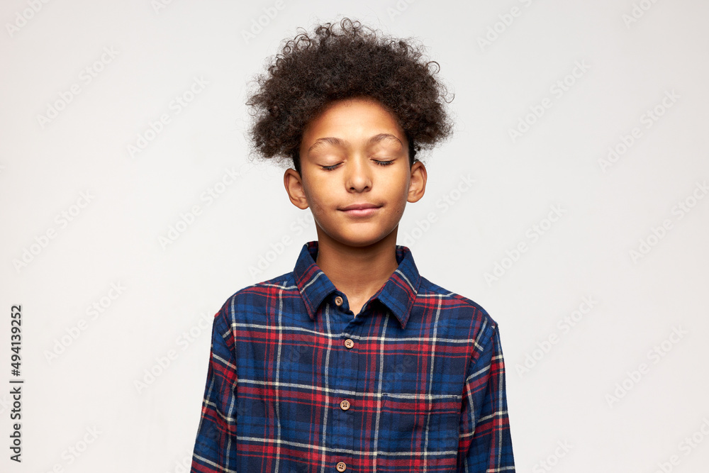 Sleepy cute positive adorable boy in flannel shirt standing against ...