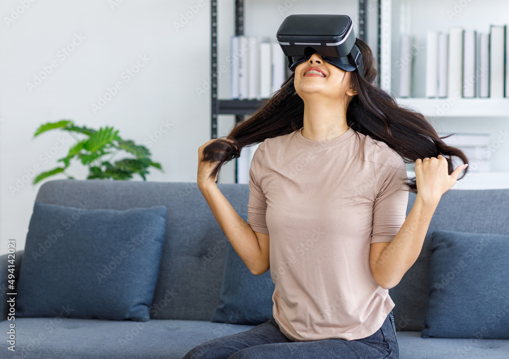 Asian young cheerful happy female gamer model wearing virtual reality ...