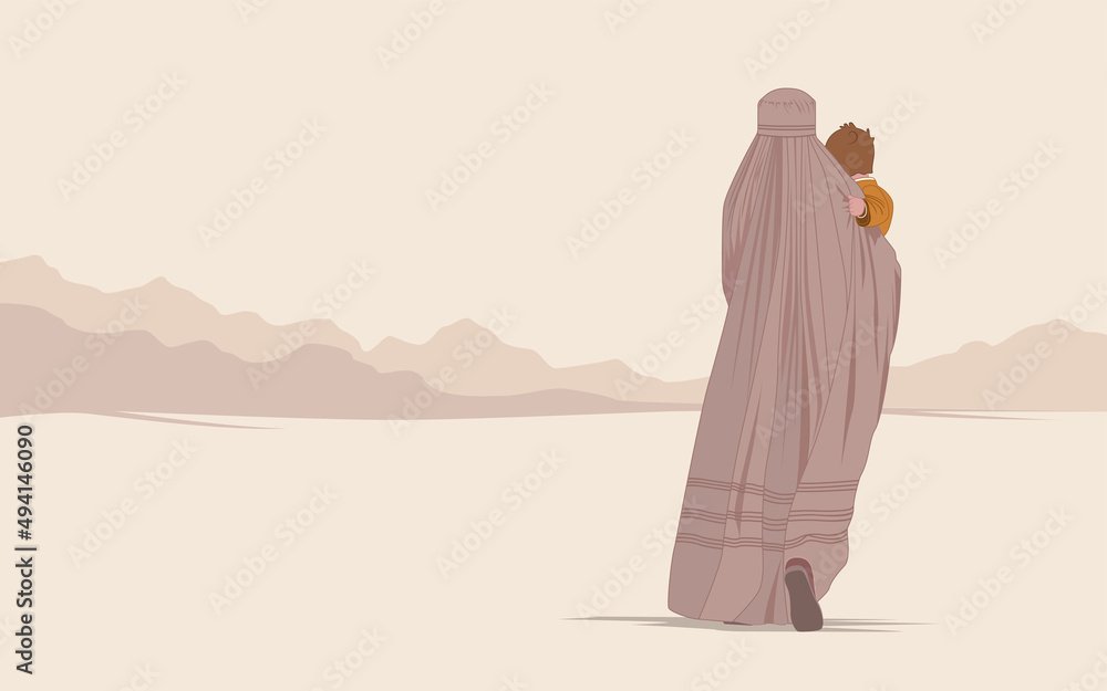 An Afghan woman in a burqa or burka with a child walks through the ...