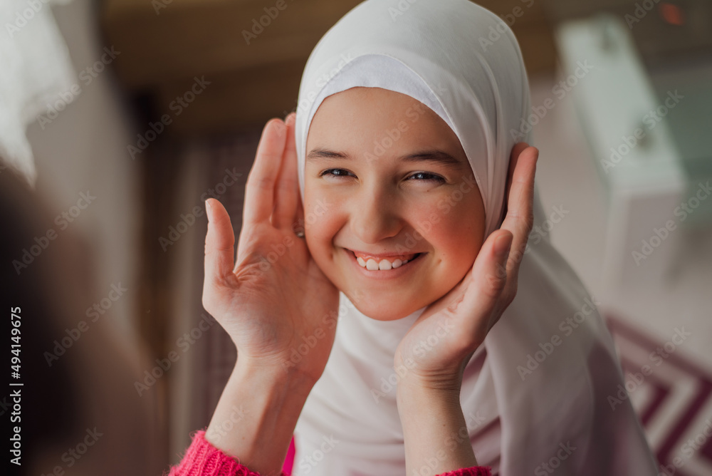 Happy Muslim family. Mother holding her child daughter in hand. Mom and ...