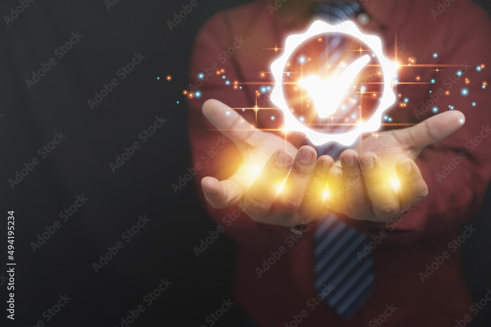 Businessman hand showing the sign of the top service quality assurance ...