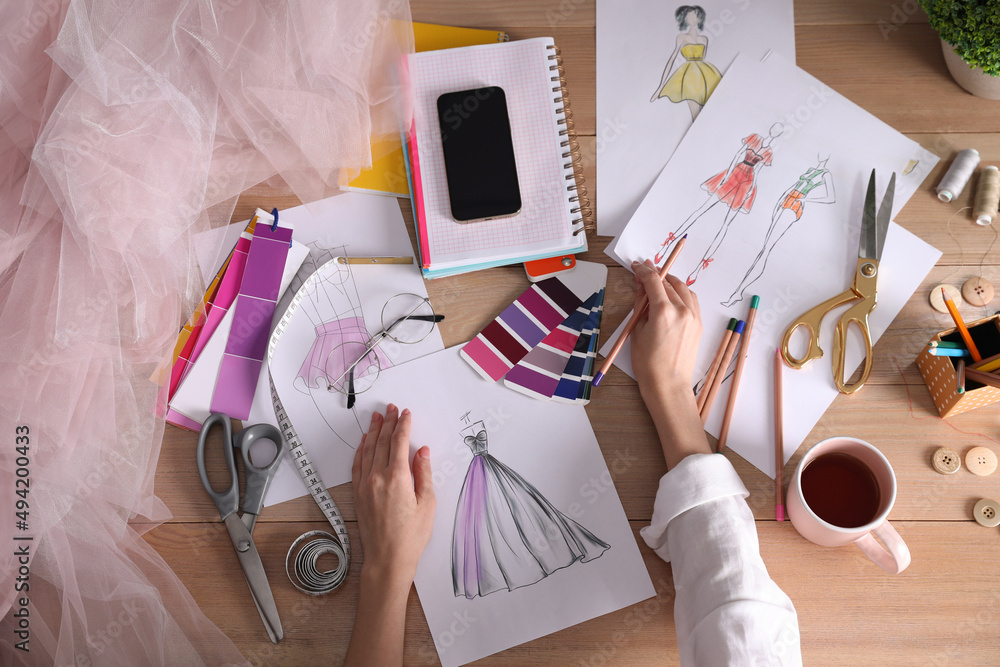 Fashion designer drawing sketch at wooden table, top view Stock Photo ...
