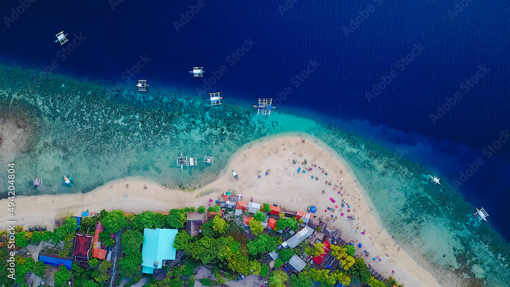Aerial view of sandy beach with tourists swimming in beautiful clear ...