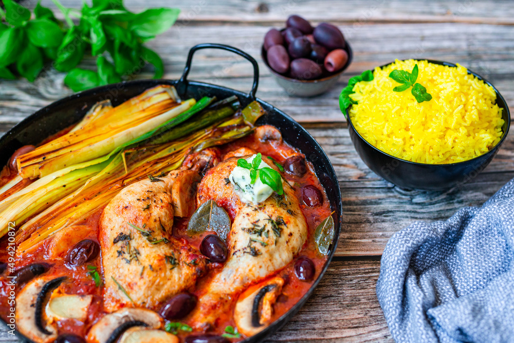 Oven roasted chicken legs with grilled leek, olives and mushroom in ...