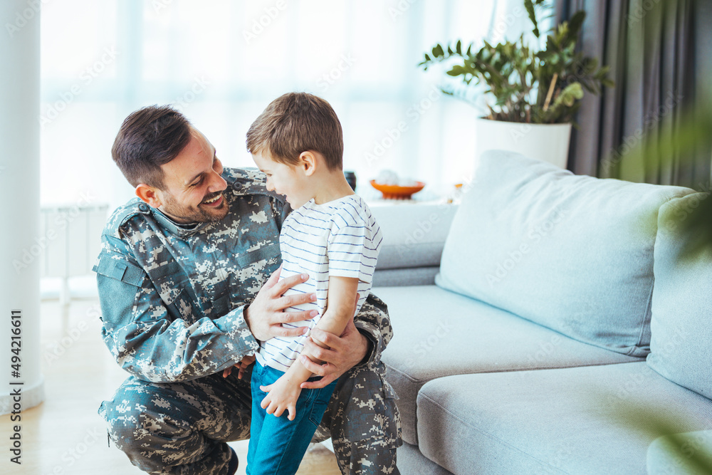 Foto de Military man father hugs son. Portrait of happy american family ...