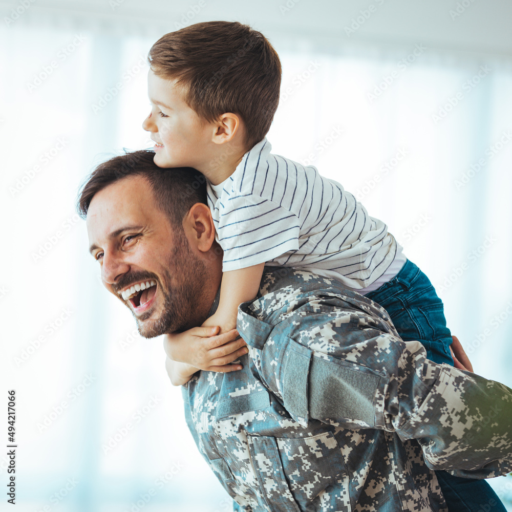 Smiling soldier reunited with his son after coming back from war ...