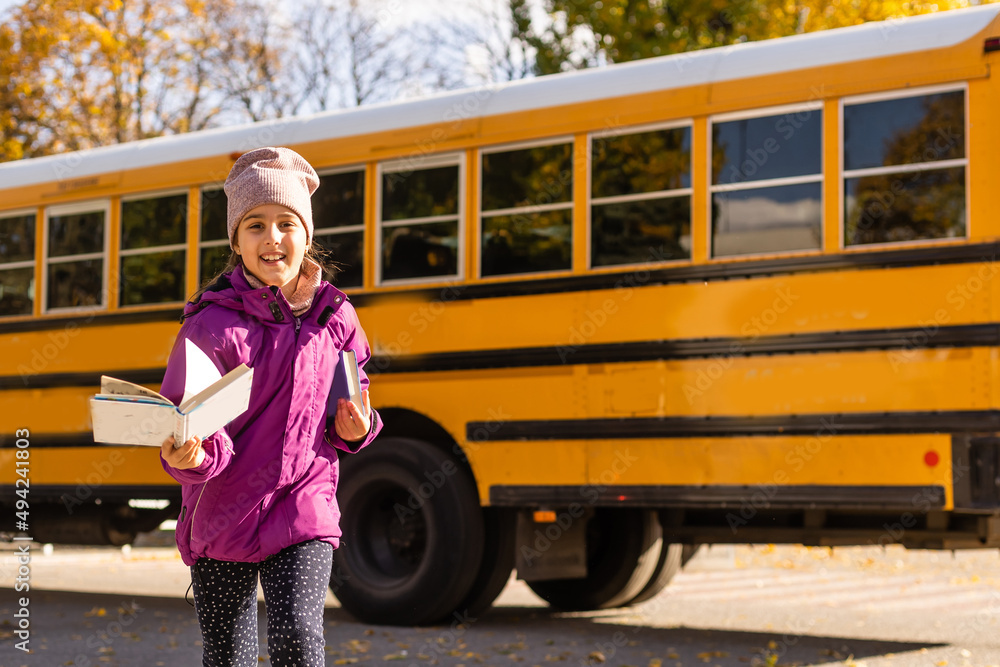 Pre teen girl getting on school bus Stock Photo | Adobe Stock