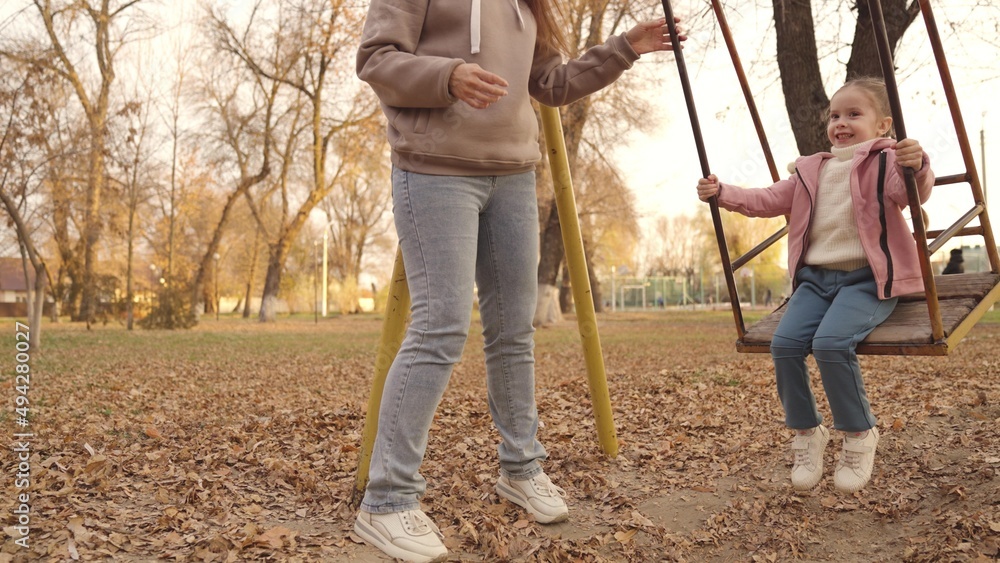 little child kid swings swing park. happy family. girl daughter dreams ...