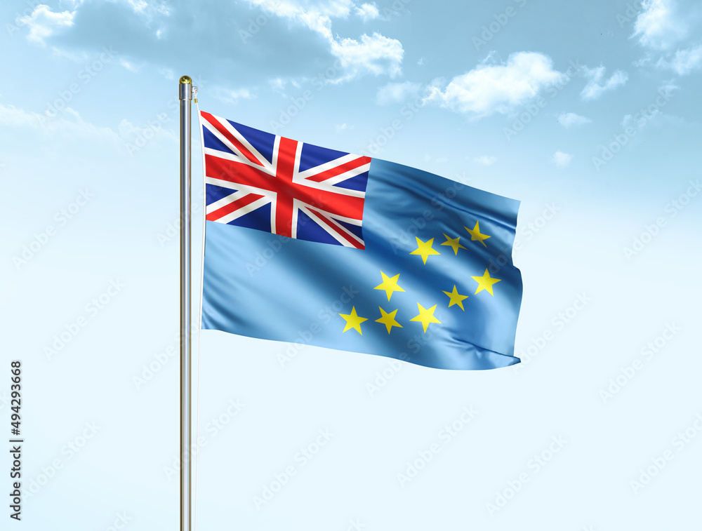 Tuvalu national flag waving in blue sky with clouds. Tuvalu flag. 3D ...