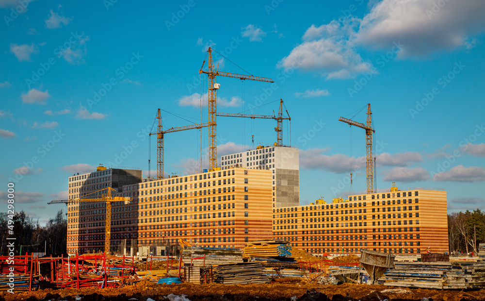 View of the construction of new high-rise buildings with tower cranes ...