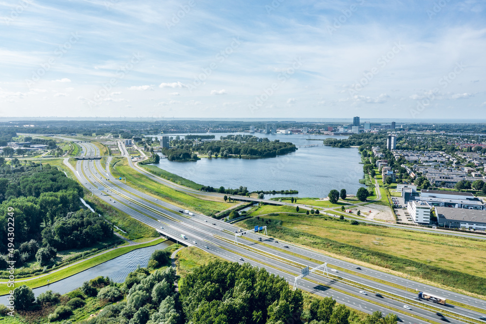 Aerial view on Almere city center, Weerwater lake, A6 highway and ...