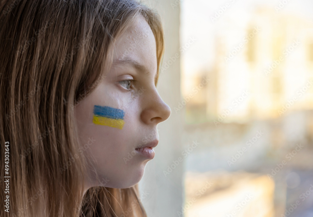War. Russia's invasion of Ukraine. Portrait of a child with tears in ...