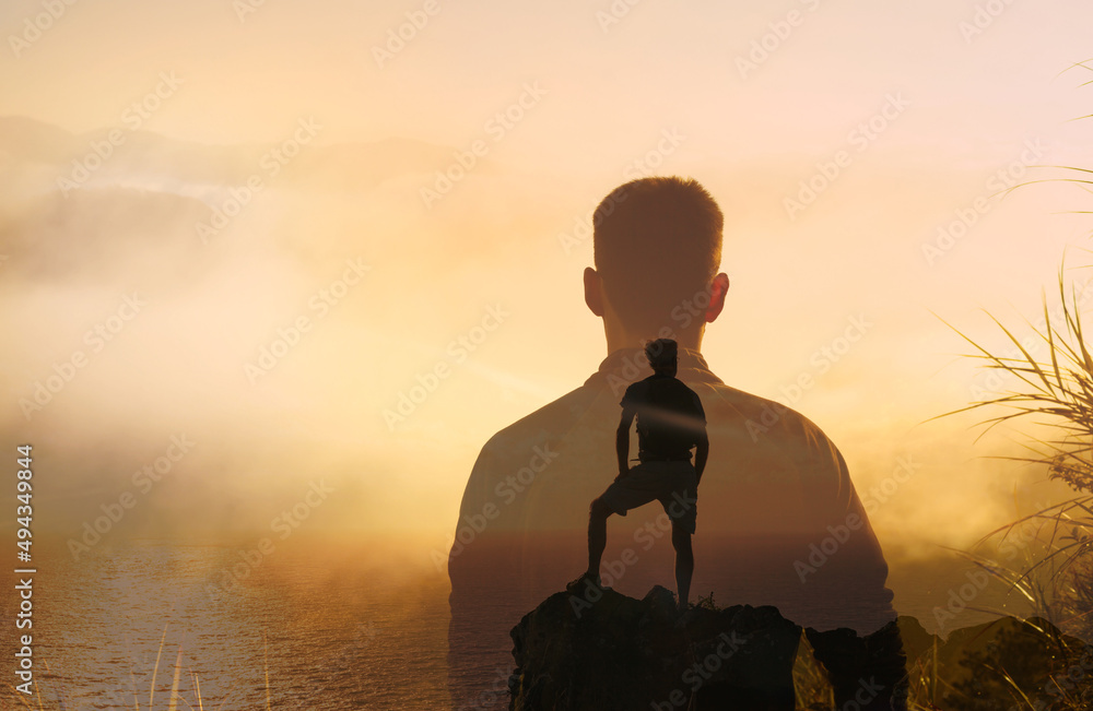 Strong determined man standing on mountain peak. Win goal setting and ...