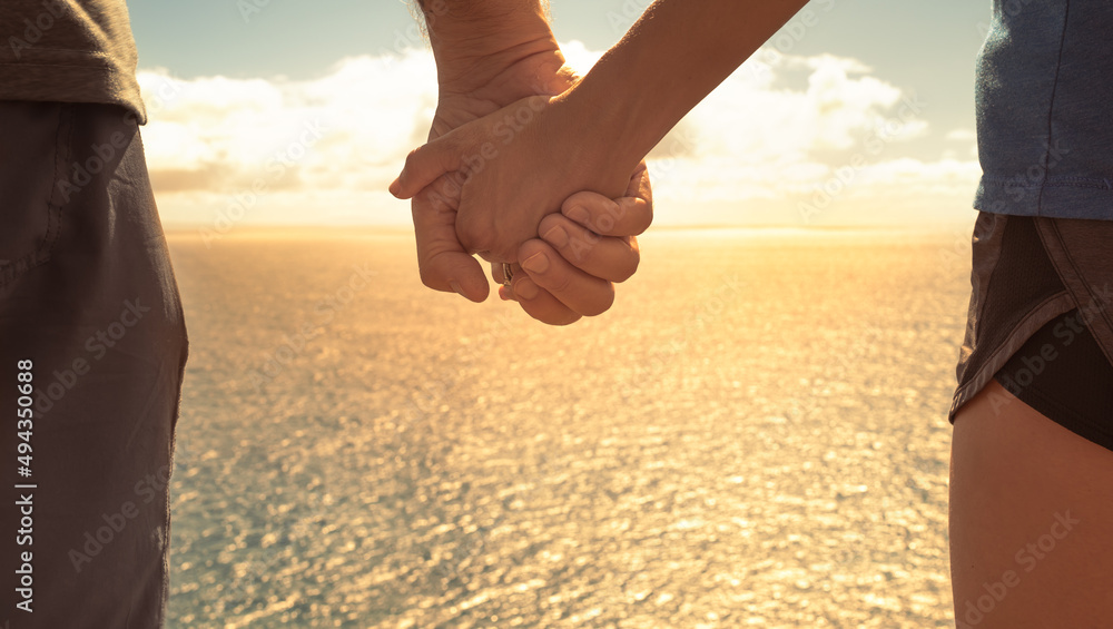 Couple flying hands facing ocean sunrise Stock Photo | Adobe Stock