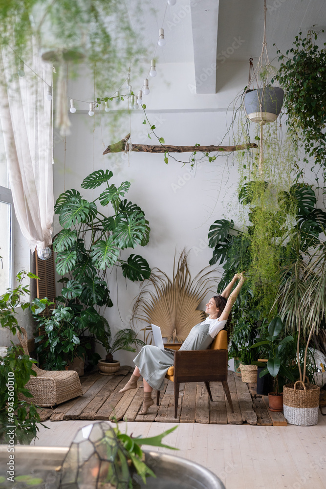 Happy relaxed woman remote worker resting, stretching arms while ...