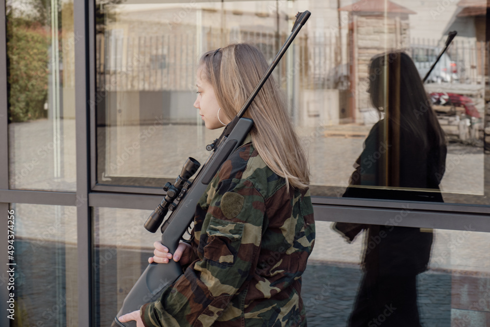 caucasian blond teen aged soldier girl on a checkpoint holding a rifle ...