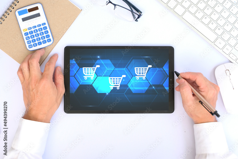 Hand using lablet analyzing sales data and customer shopping behavior ...